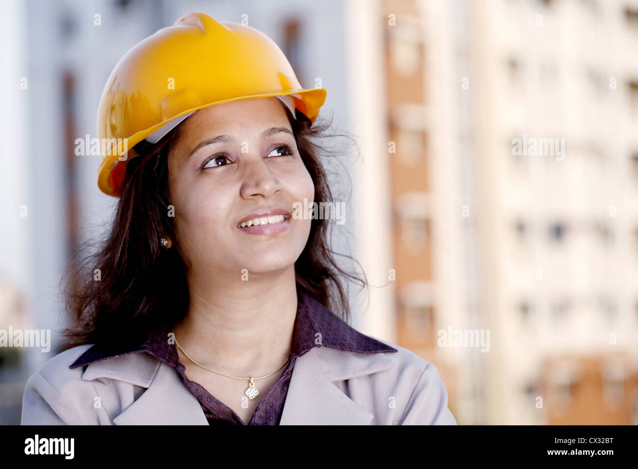 Young Indian female construction engineer looking up Stock Photo - Alamy