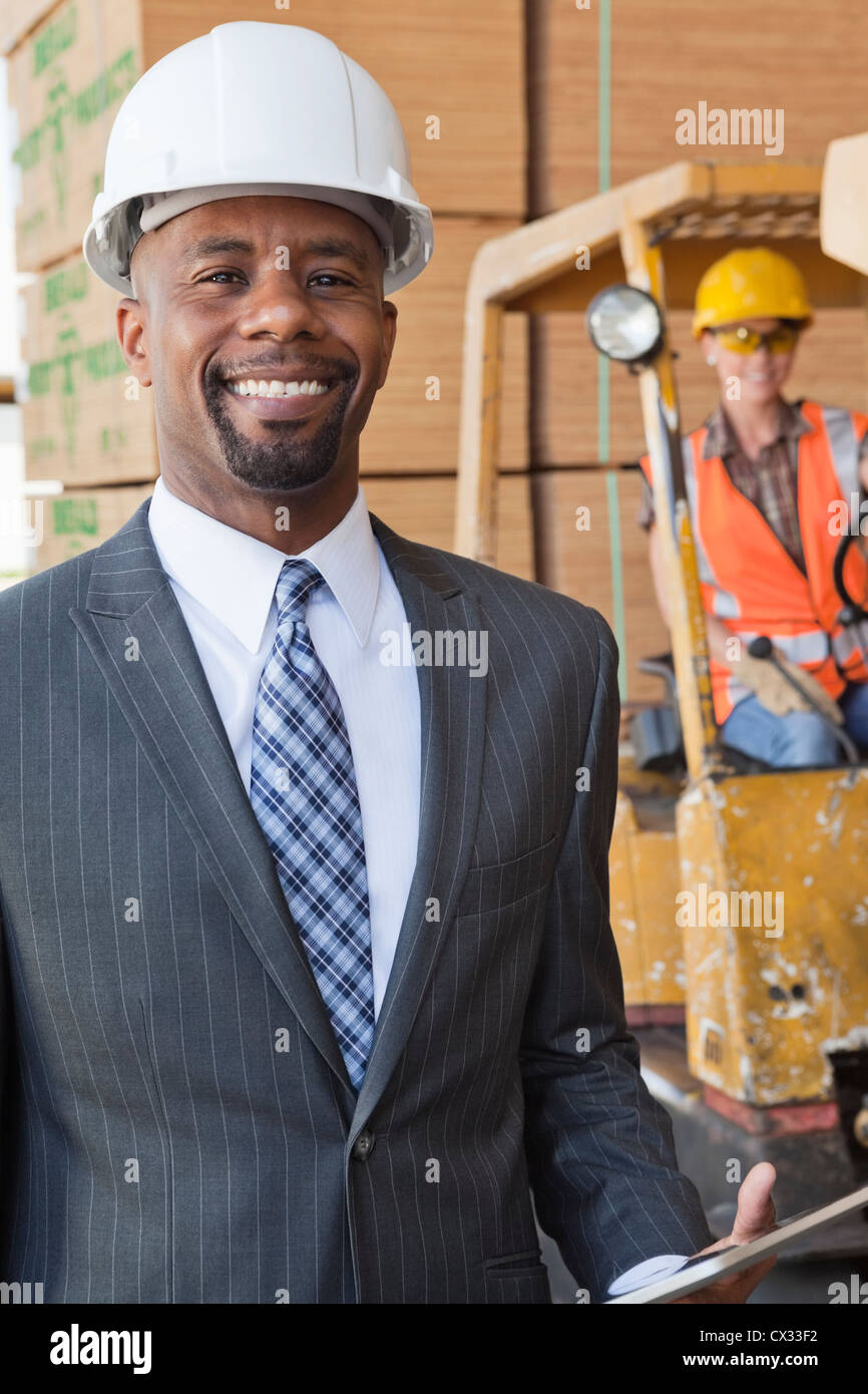 Portrait of African American male engineer smiling with female worker ...