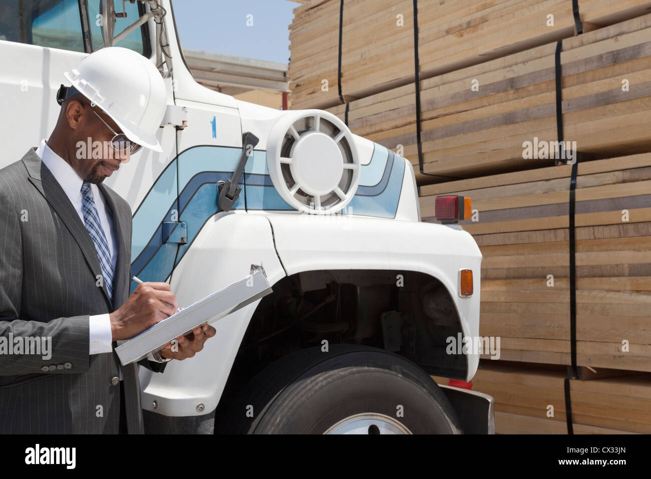 African American male contractor writing notes while standing by ...