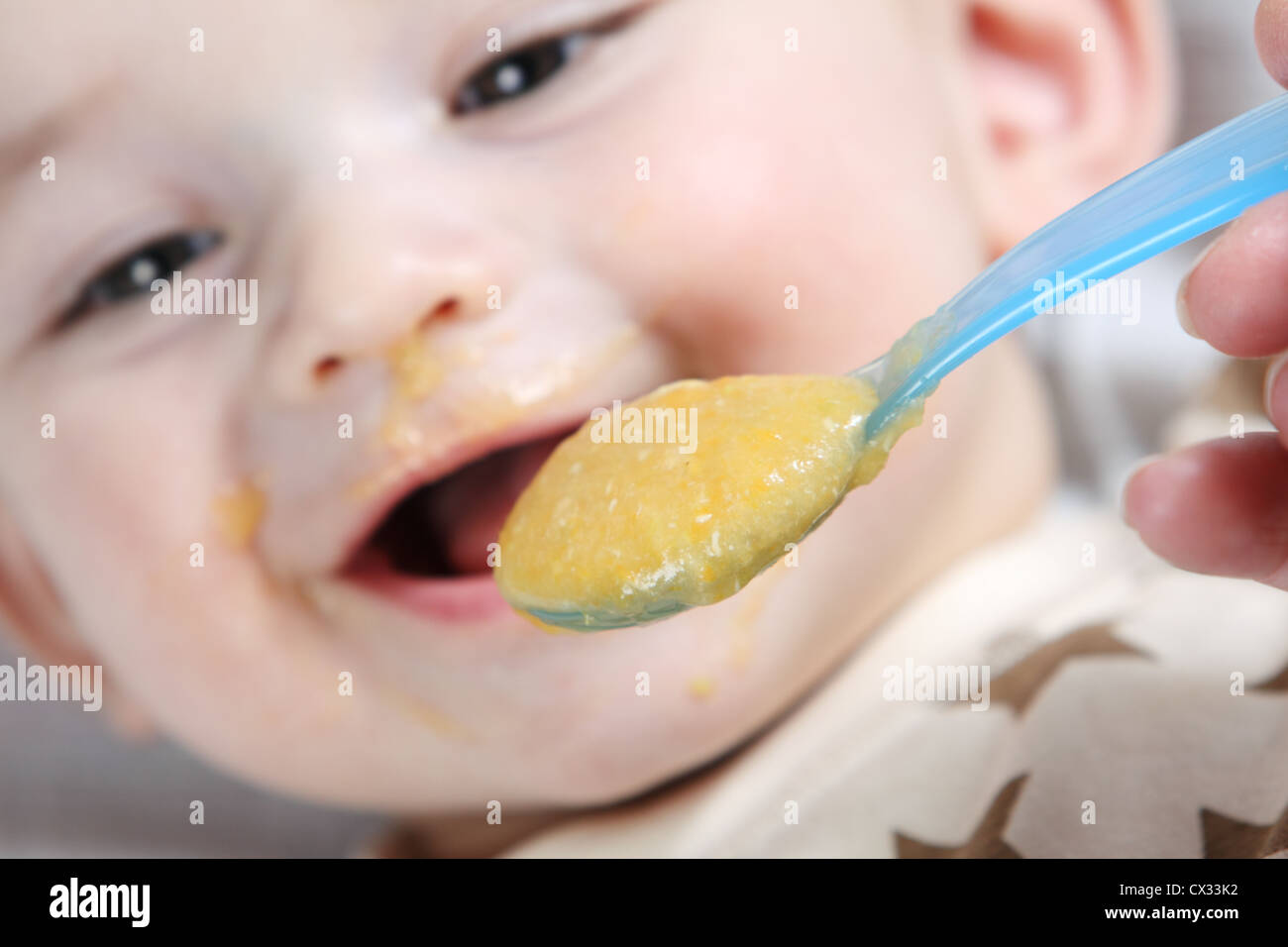 Detail newborn face with first baby food Stock Photo - Alamy
