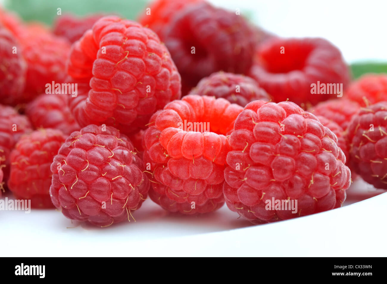 close-up on raspberries arranged on white background Stock Photo - Alamy