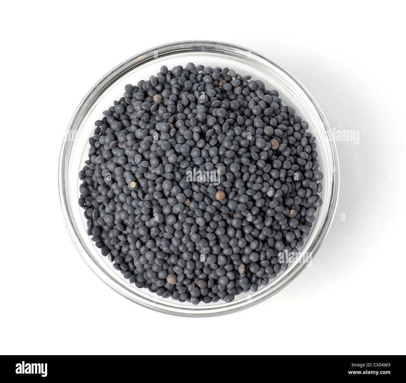 Black lentil in plate isolated on white Stock Photo - Alamy