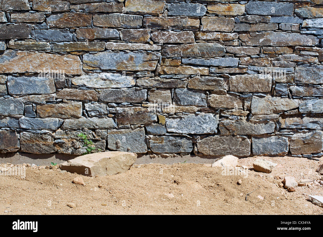 A Stone granite wall and sand floor Stock Photo - Alamy