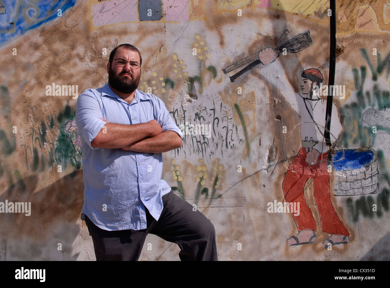 "Breaking the Silence" founder Yehuda Shaul stands in front of a wall ...