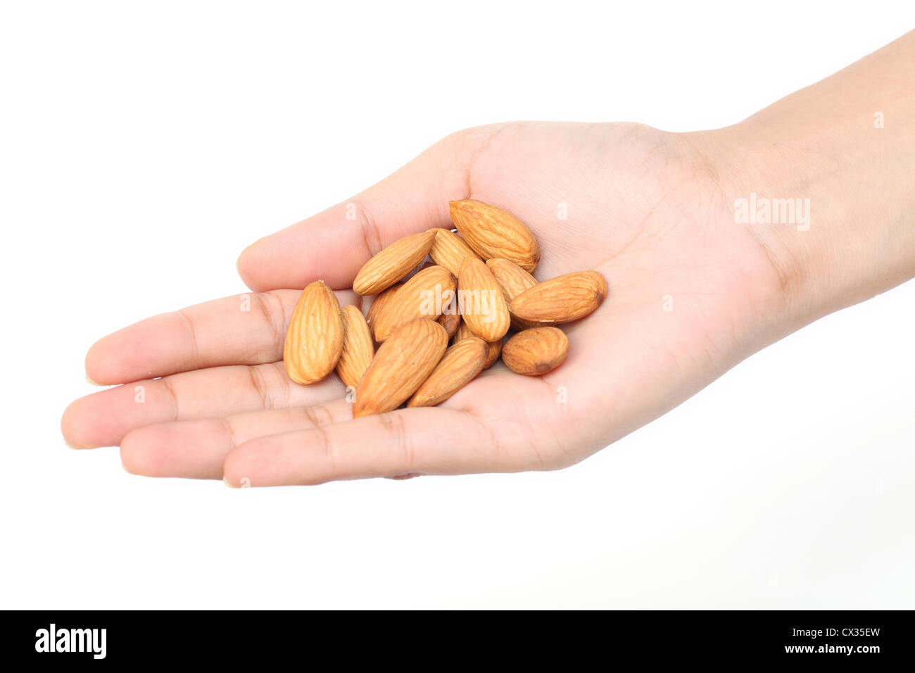 Handful of almonds against white background Stock Photo - Alamy