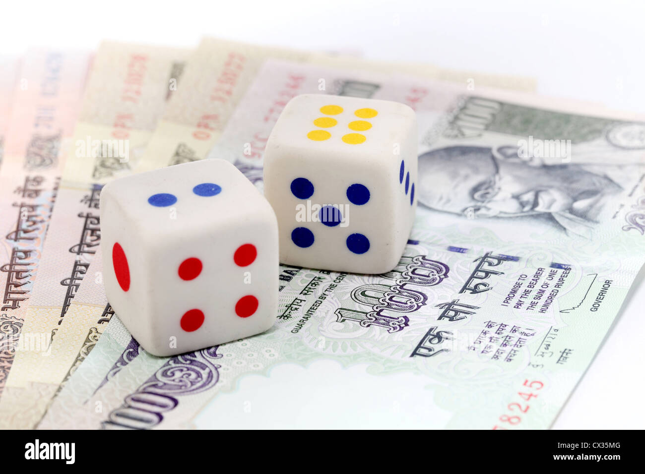 Dice on Indian rupee notes on white background Stock Photo - Alamy