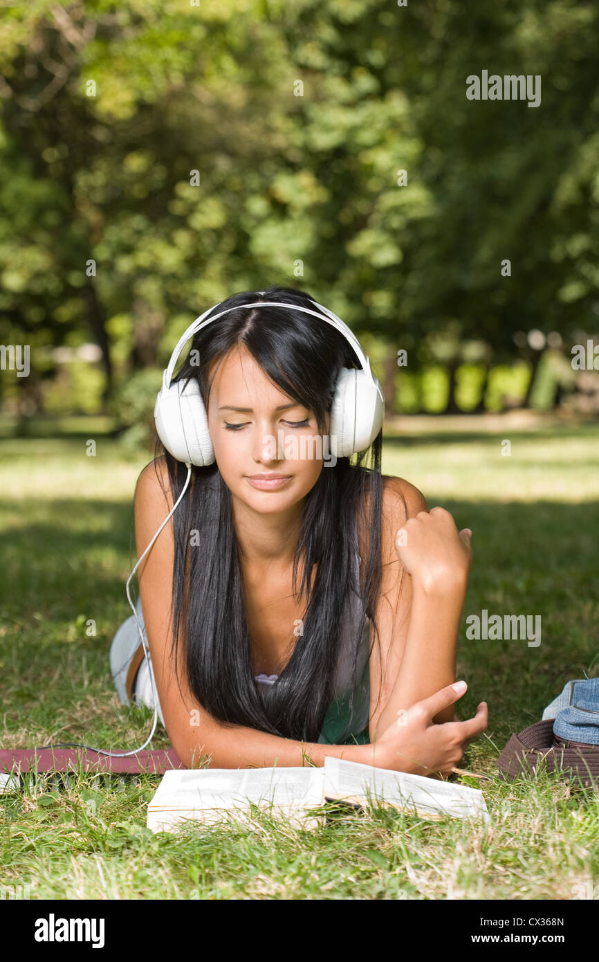 Portrait of a relaxed beautiful young student girl relaxing, studying ...