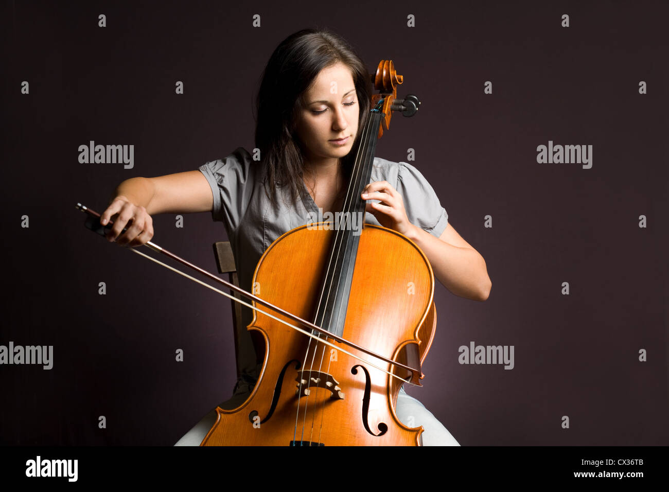 Passionate real artist, young woman playing her classical instrument ...
