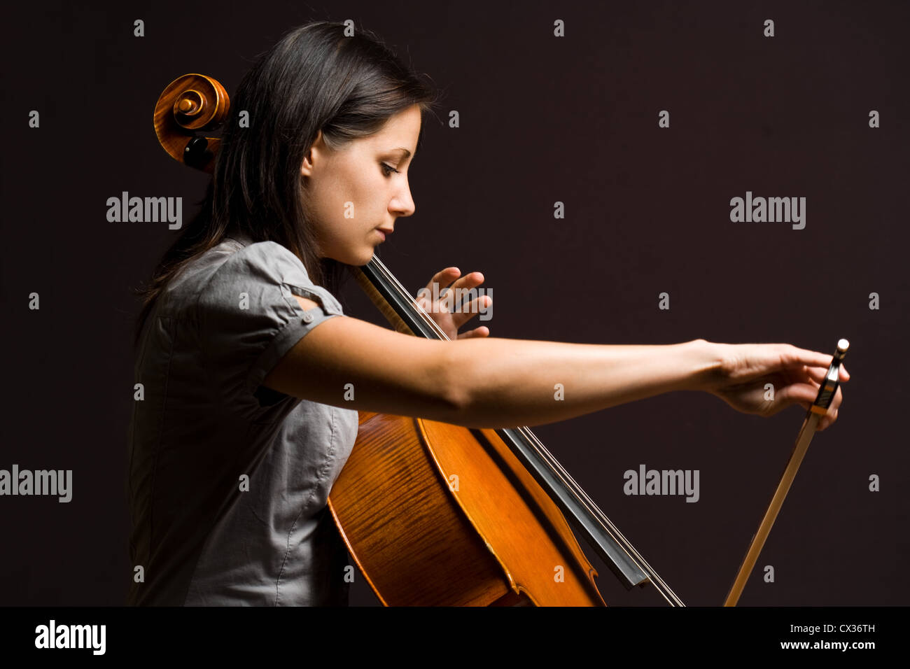 Portrait of beautiful young cellist immersed passionate in her music ...