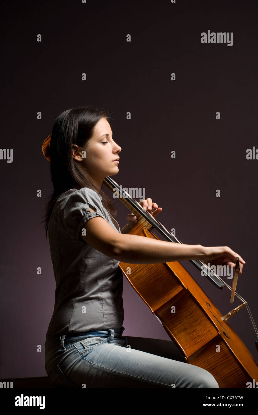 Passionate real artist, young woman playing her classical instrument ...