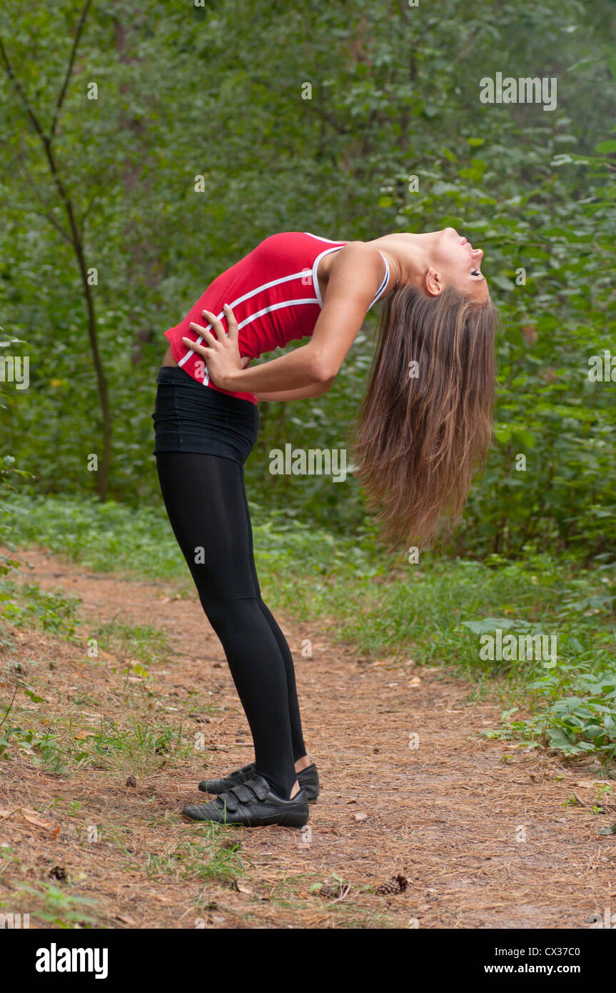 Beautiful girl doing morning exercises in park Stock Photo - Alamy