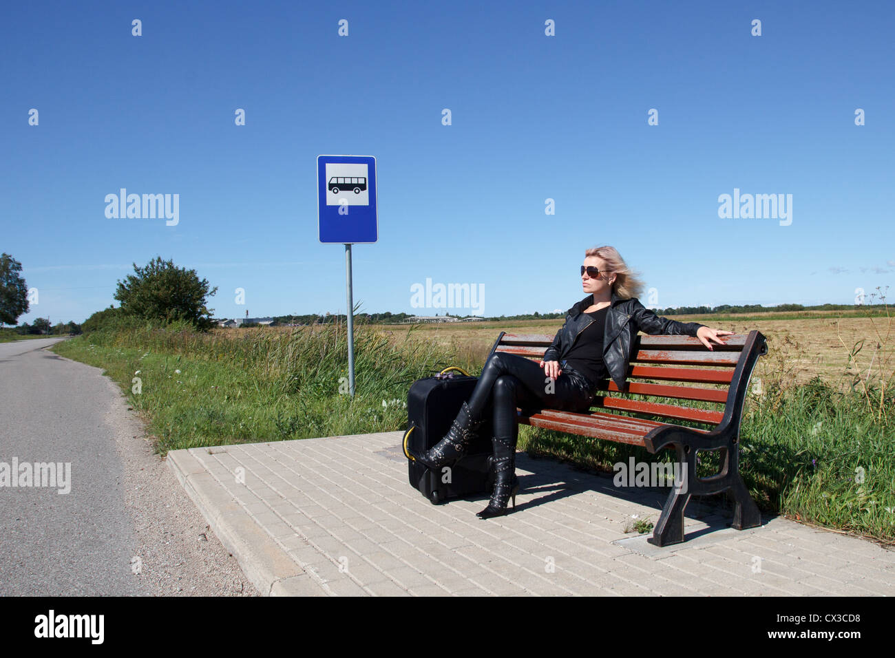 Sitting on bus stop bench hi-res stock photography and images - Alamy