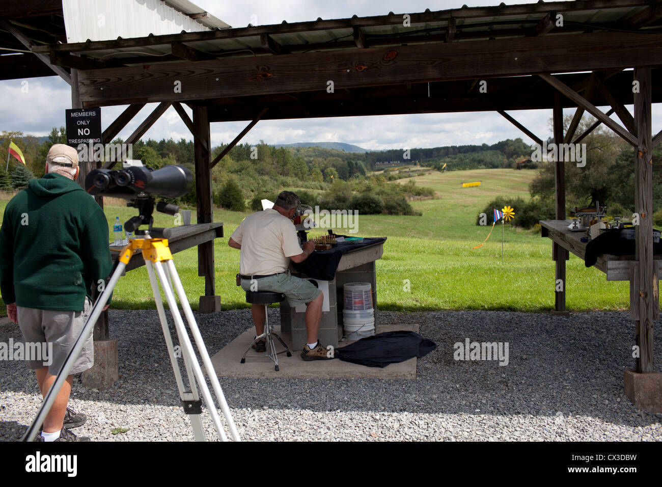 A benchrest shooter, center, adjusts his .30 caliber custom made rifle ...