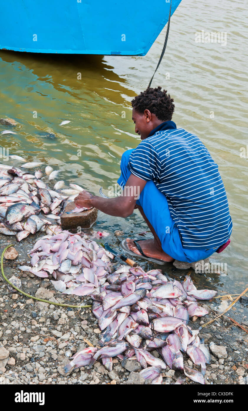 Lake Langano Ethiopia Africa Oromo Tribe boy cleaning fish from lake to ...