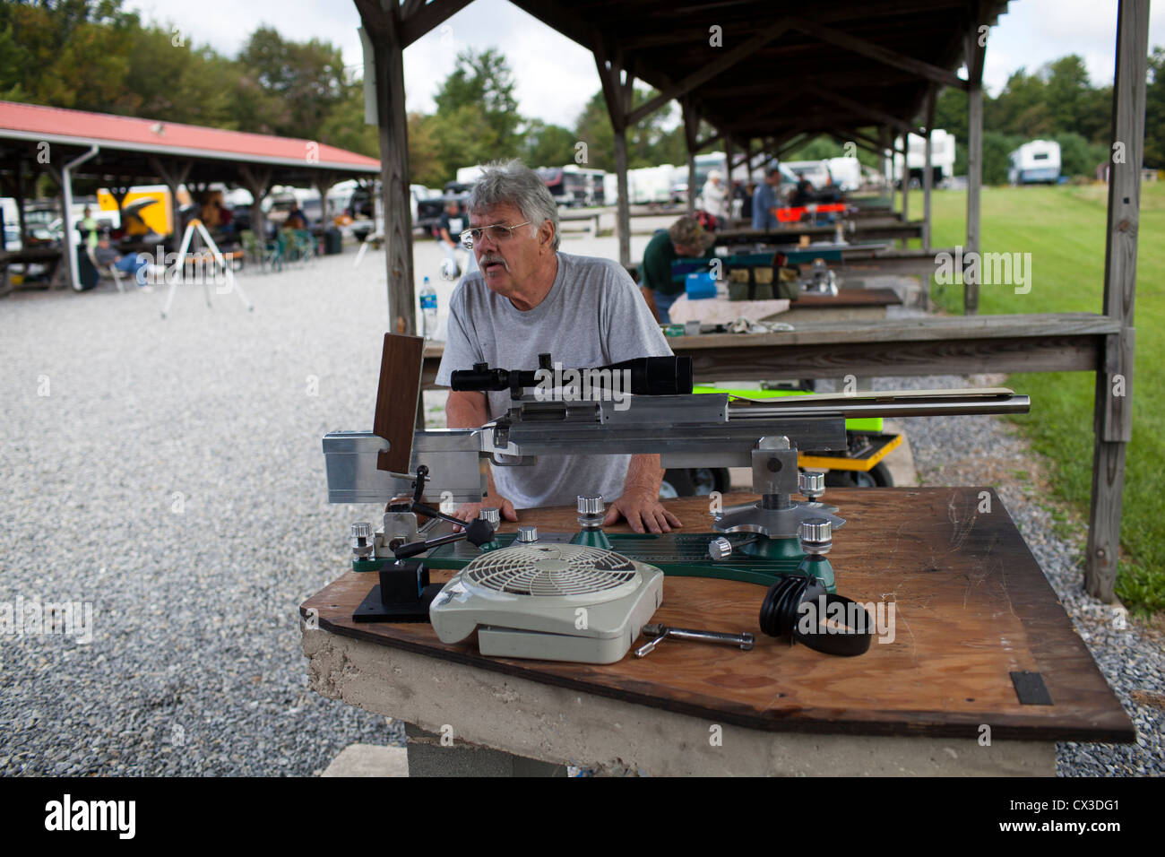 A benchrest shooter adjusts his .30 caliber custom made rifle at the ...