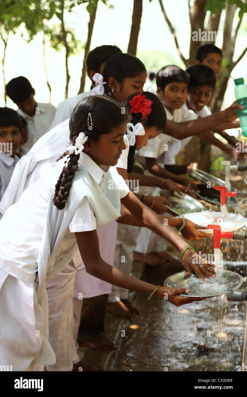 School children cleaning their plates for lunch break Andhra Pradesh ...