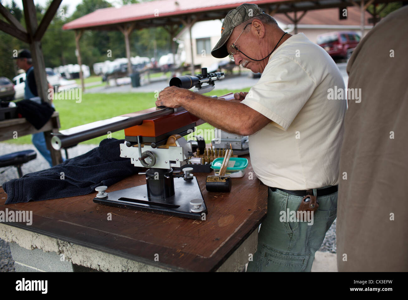 A benchrest shooter adjusts his .30 caliber custom made rifle at the ...