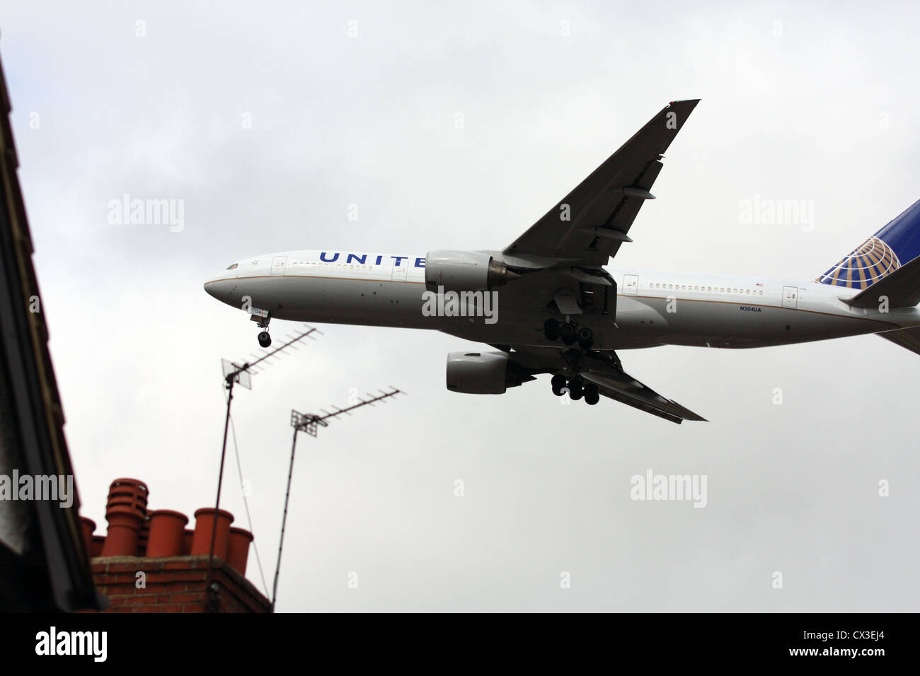 An aircraft flying over houses as it comes in to land at Heathrow ...