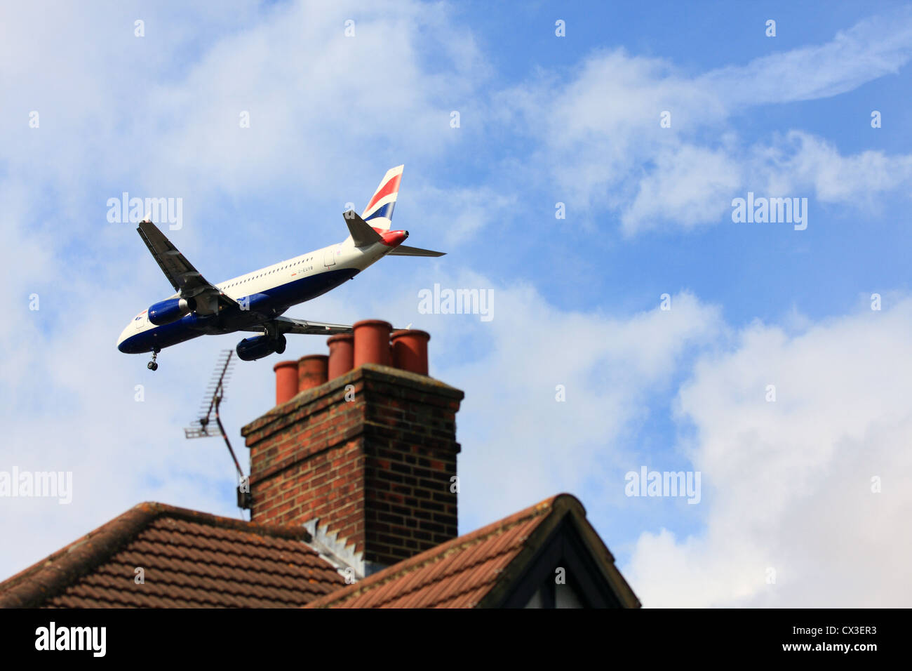 An aircraft flying over houses as it comes in to land at Heathrow ...