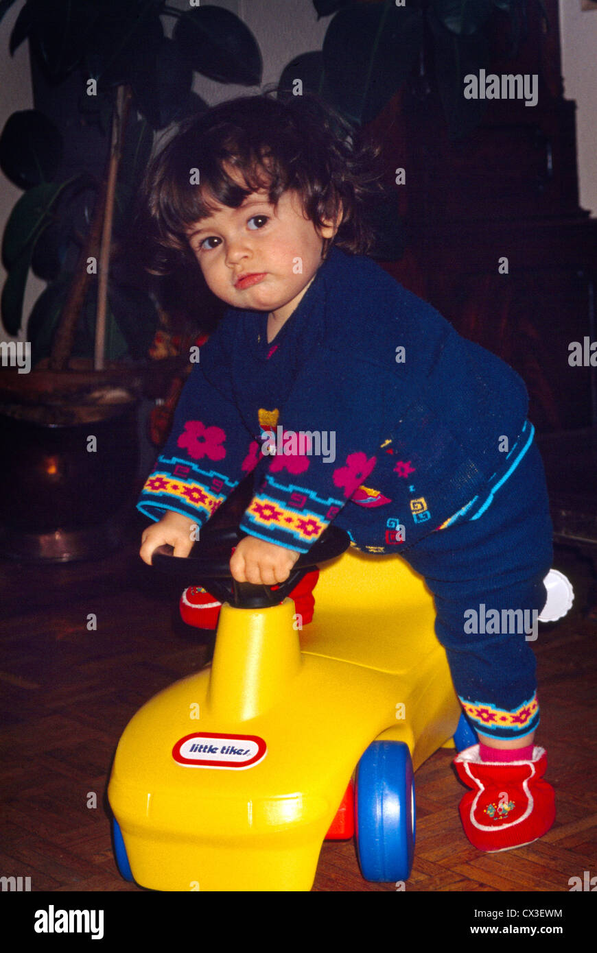 Toddler Climbing On Push Along Car Stock Photo - Alamy