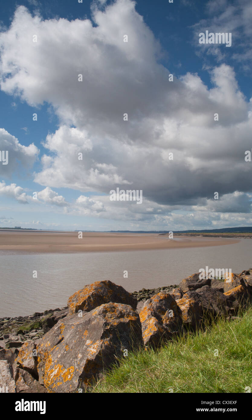 river bank flood defences, grassy bank, low tide, dramatic sky Stock ...