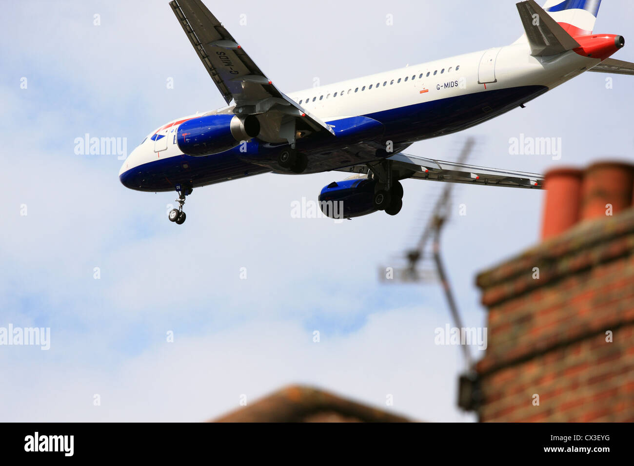 An aircraft flying over houses as it comes in to land at Heathrow ...