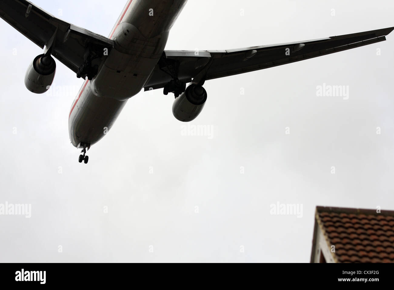 An aircraft flying over houses as it comes in to land at Heathrow ...