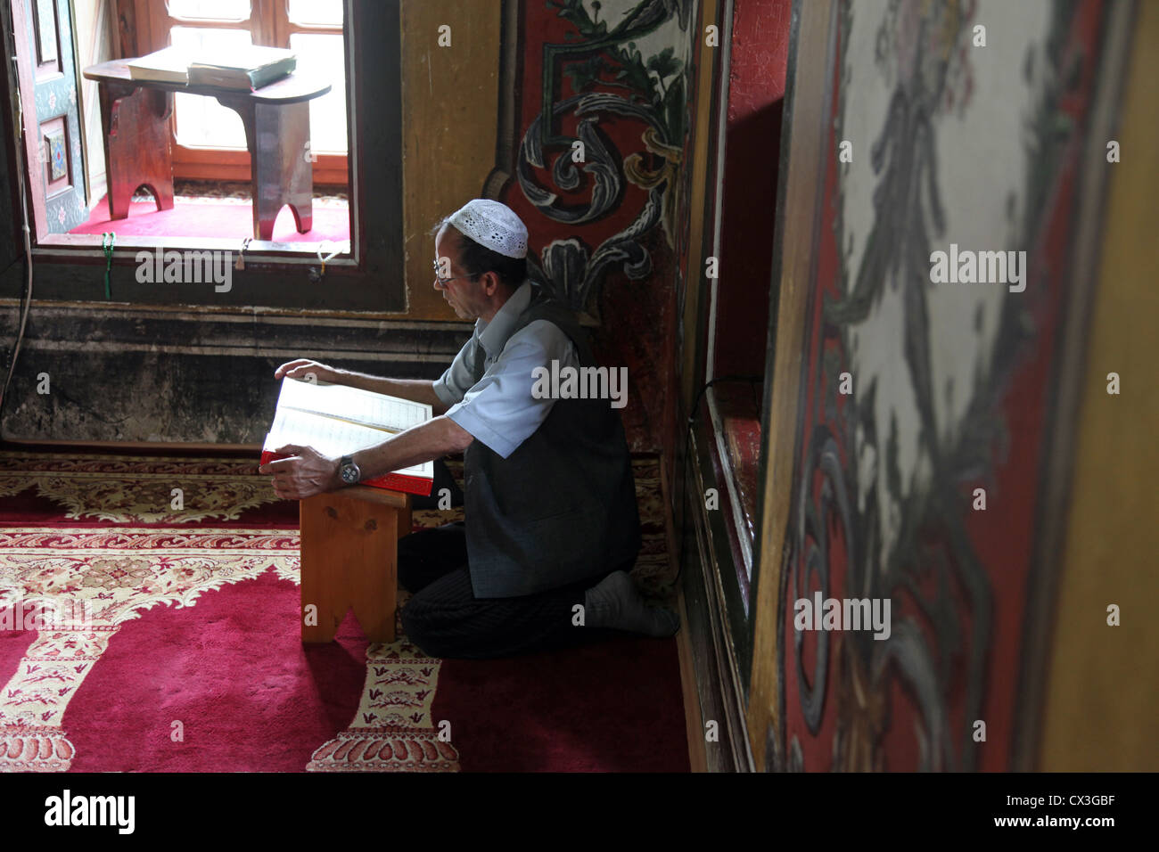 Muslim man reading the Koran in the Aladza painted mosque,Tetovo ...