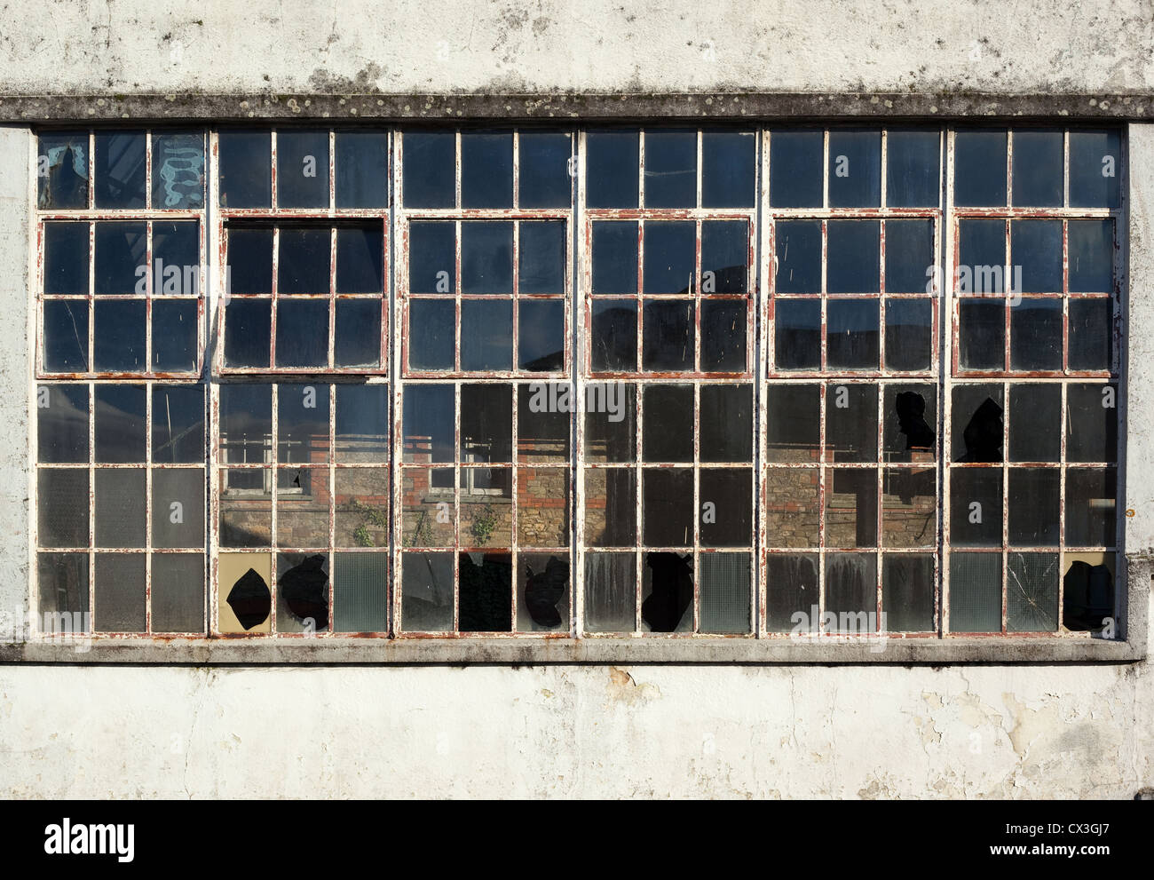 Broken windows in a derelict building about to be demolished Stock ...