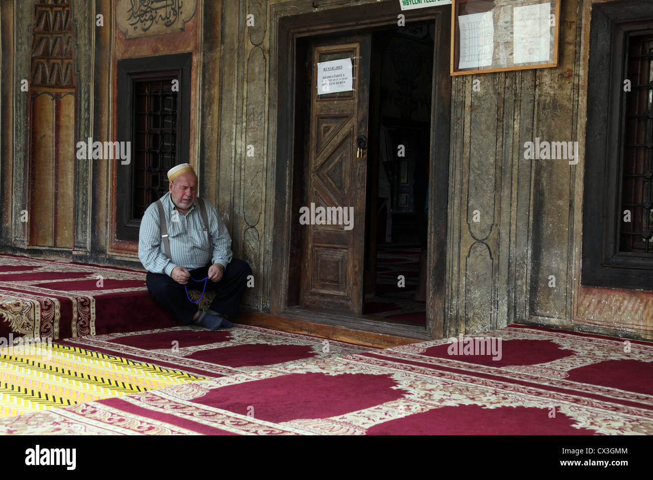 Muslim man seating in front Aladza painted mosque,Tetovo, Macedonia ...