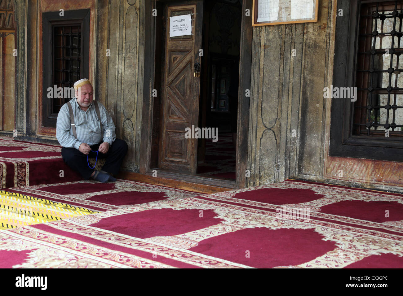Muslim man seating in front Aladza painted mosque,Tetovo, Macedonia ...