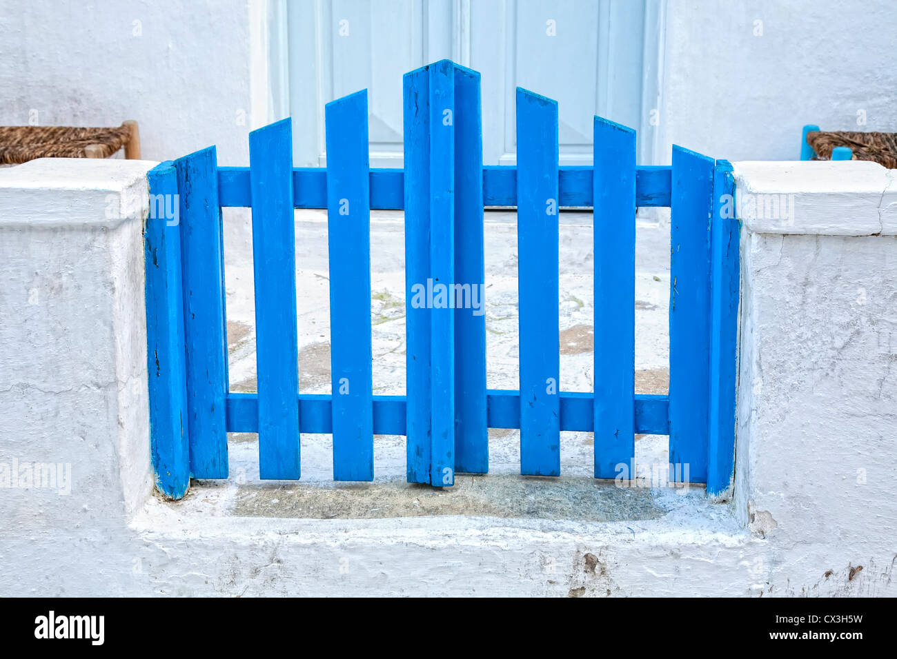 The tradional bright blue color on a wooden front gate of a home on the ...