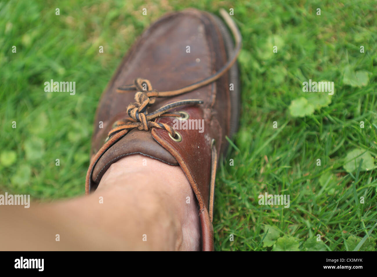 Mans left foot in Boater shoe on green grass Stock Photo - Alamy