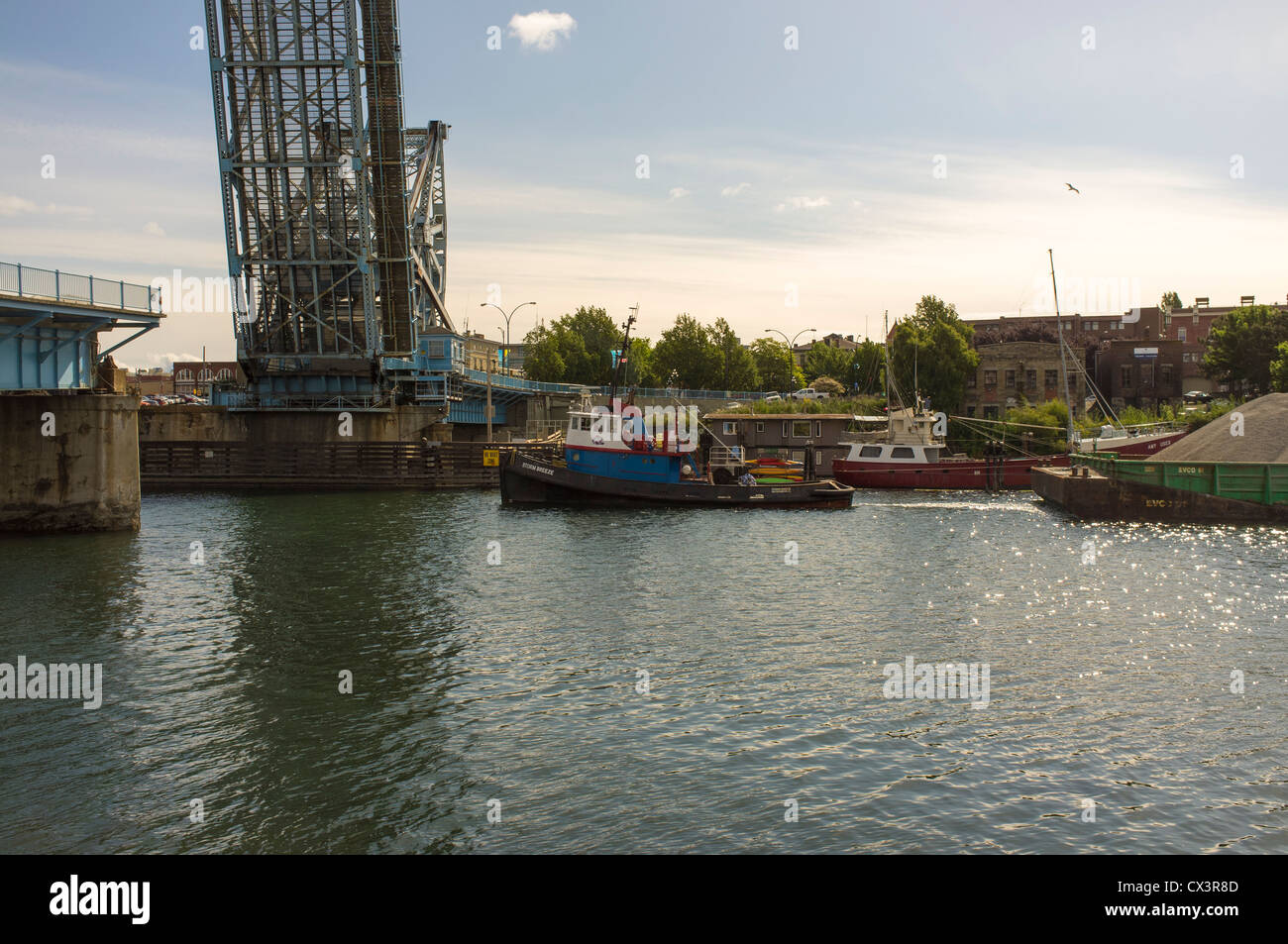 A tug and barge sail under a raised drawbridge Stock Photo - Alamy