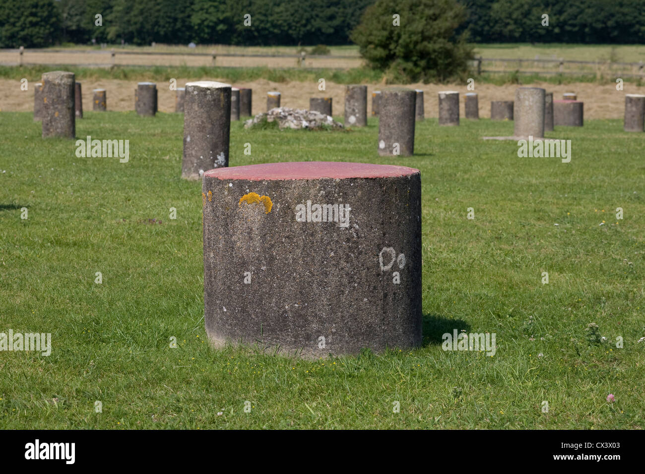 Woodhenge ancient monument, with a shorter concrete marker post in the ...