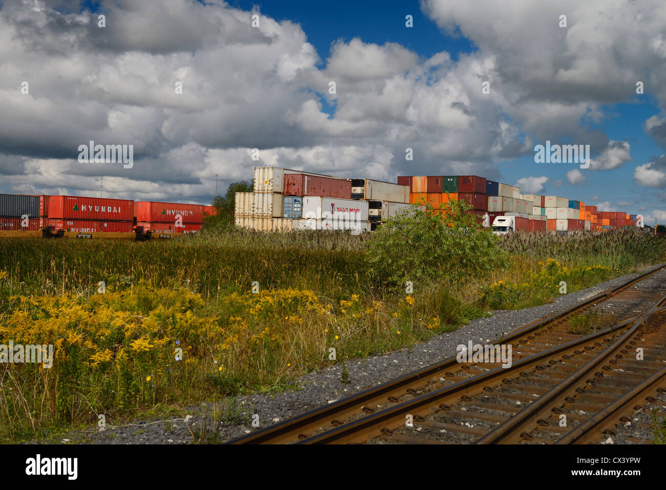 Intermodal transport containers stacked at a rail depot for delivery by ...