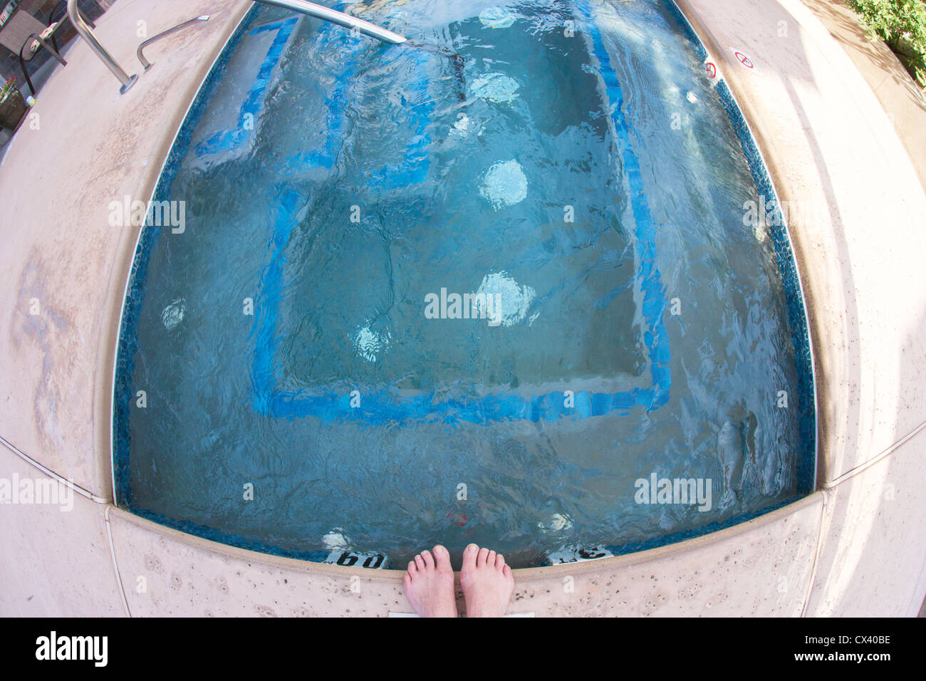 Tips of a woman's toes by a pool of hot water outdoors Stock Photo - Alamy