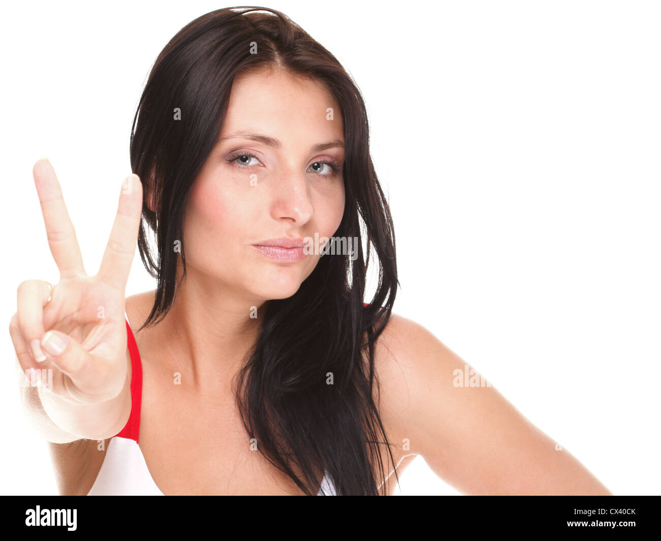 Portrait of a pretty young woman showing the peace sign Stock Photo - Alamy