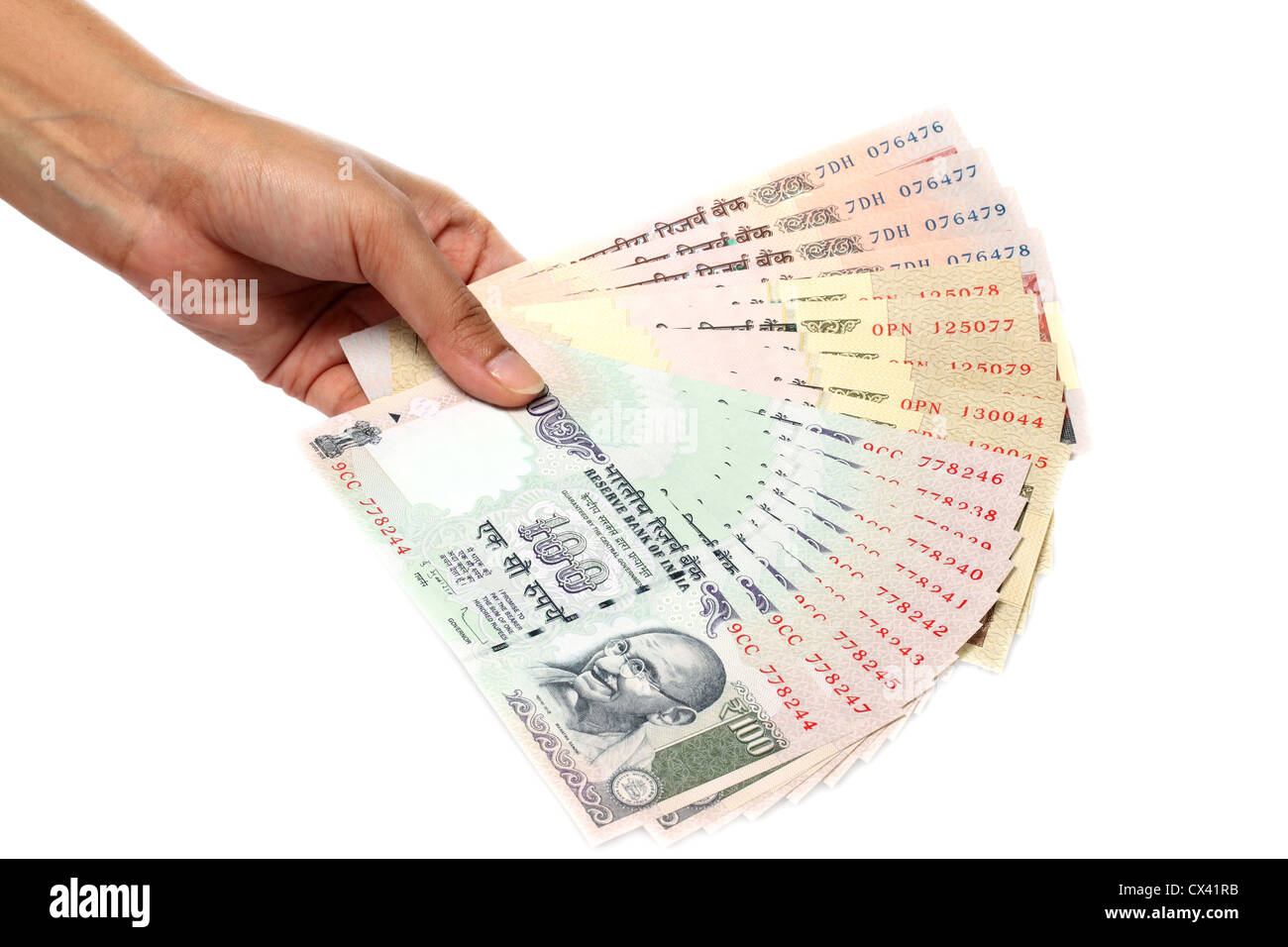 Hand holding Indian rupee notes against white background Stock Photo ...