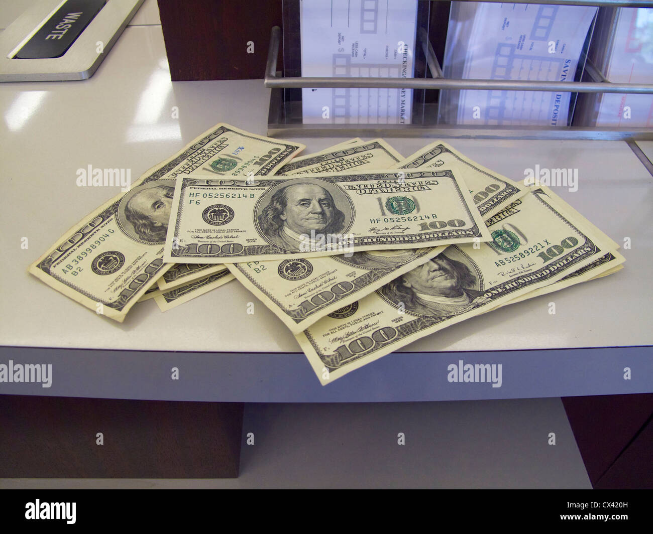 $100 U.S. currency on bank counter for deposit Stock Photo - Alamy