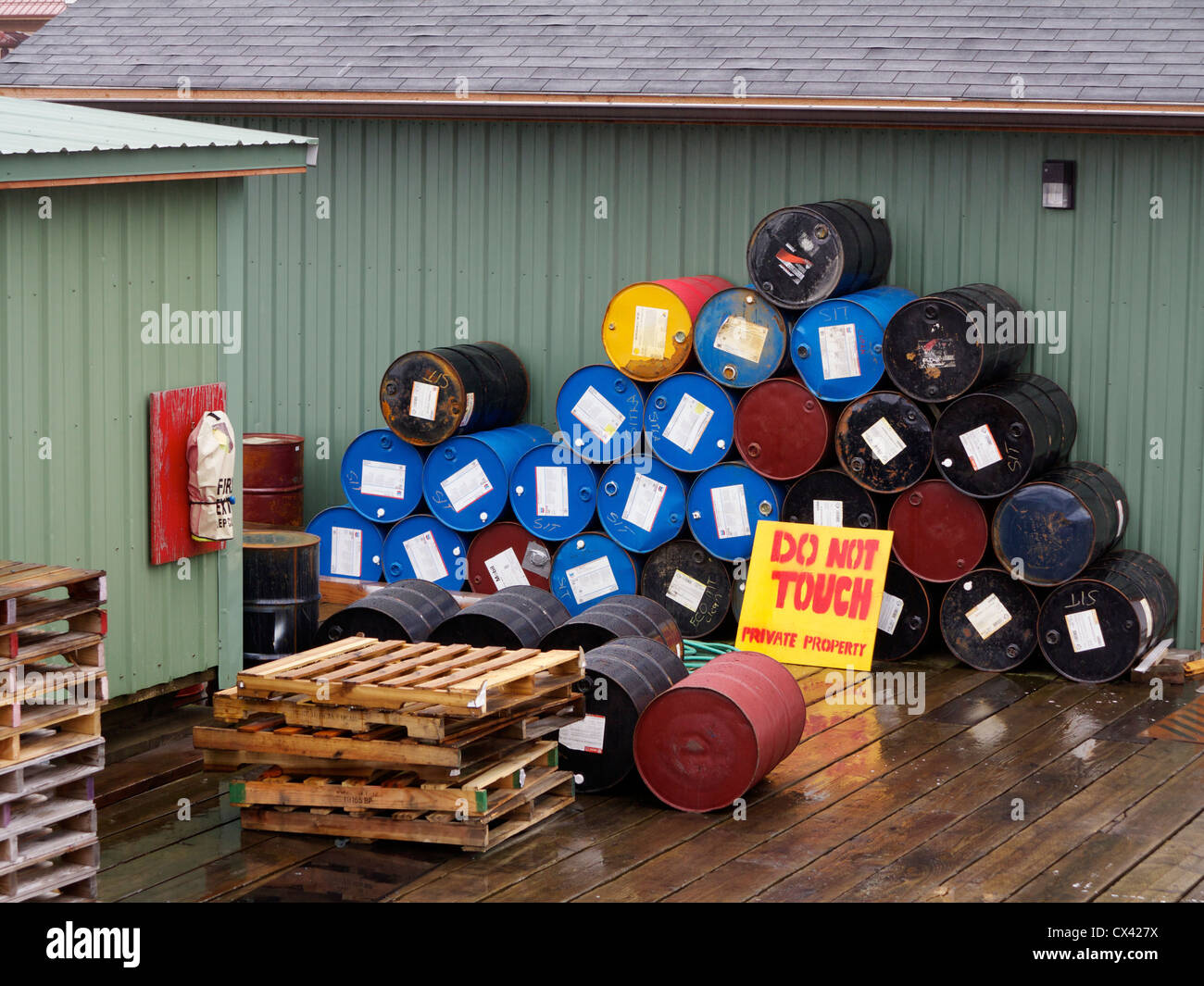 Stacked fuel barrels on dock with do not touch sign. Sitka, Alaska ...