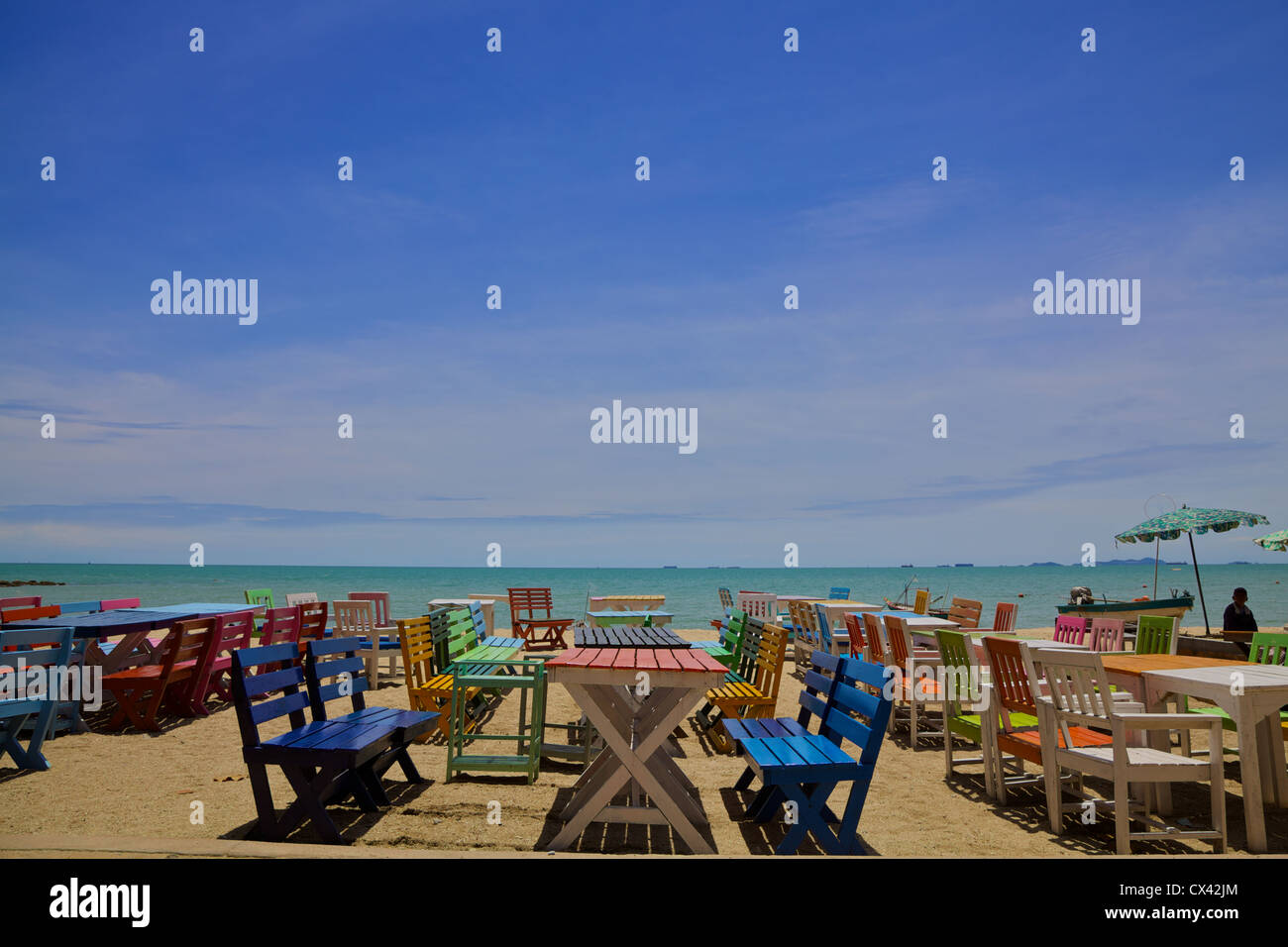 View of the sea with dining chairs and tables at Pattaya beach ...