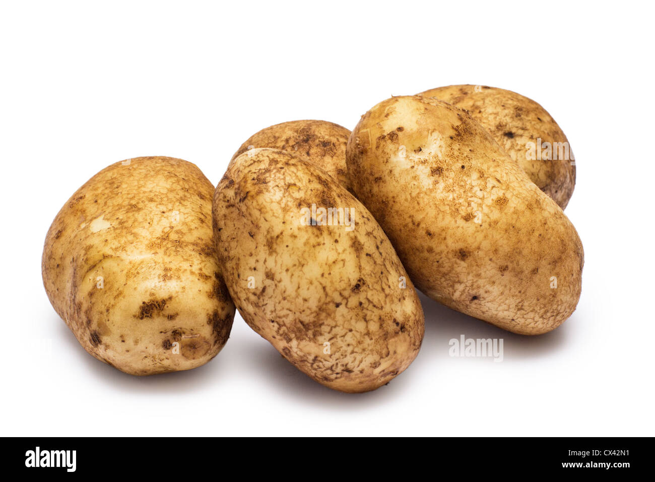 pile of washed potatoes isolated on white background Stock Photo - Alamy