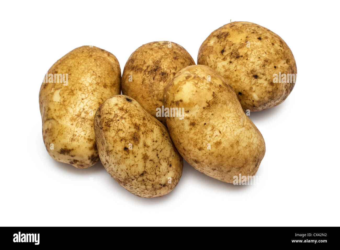 pile of washed potatoes isolated on white background Stock Photo - Alamy