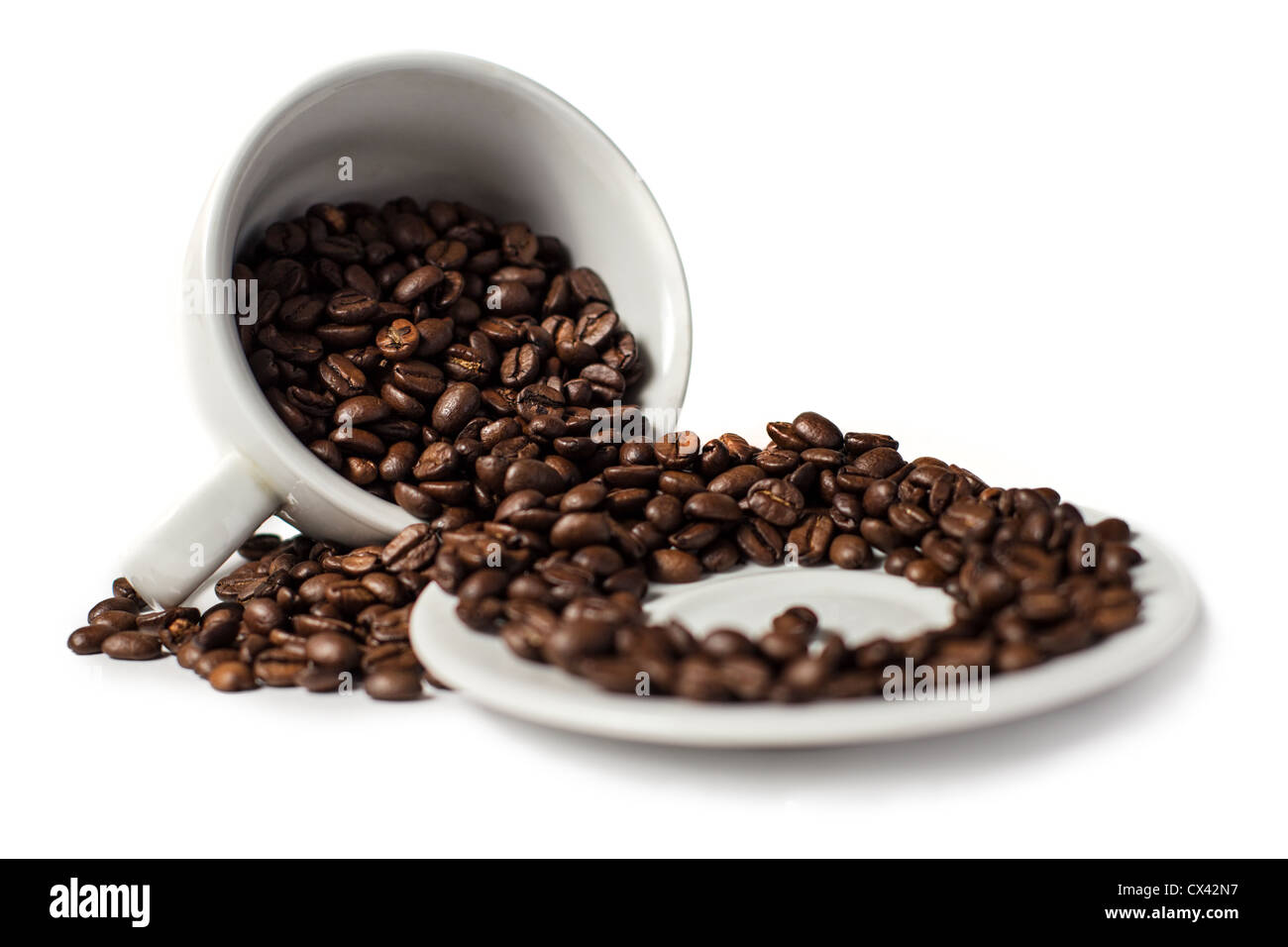 inverted cup with coffee beans on white Stock Photo - Alamy