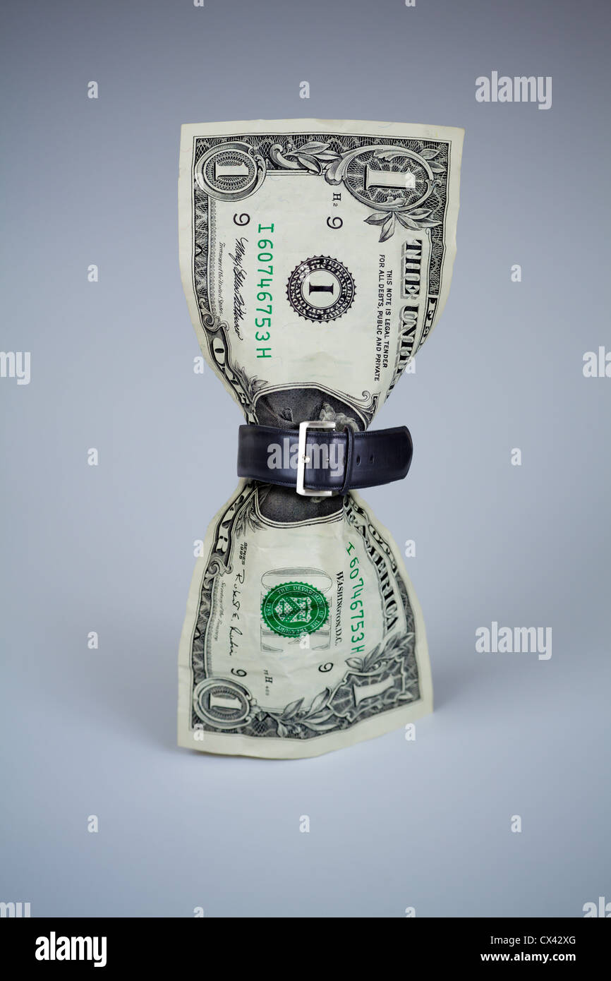 tighten belt on dollar concept Stock Photo - Alamy