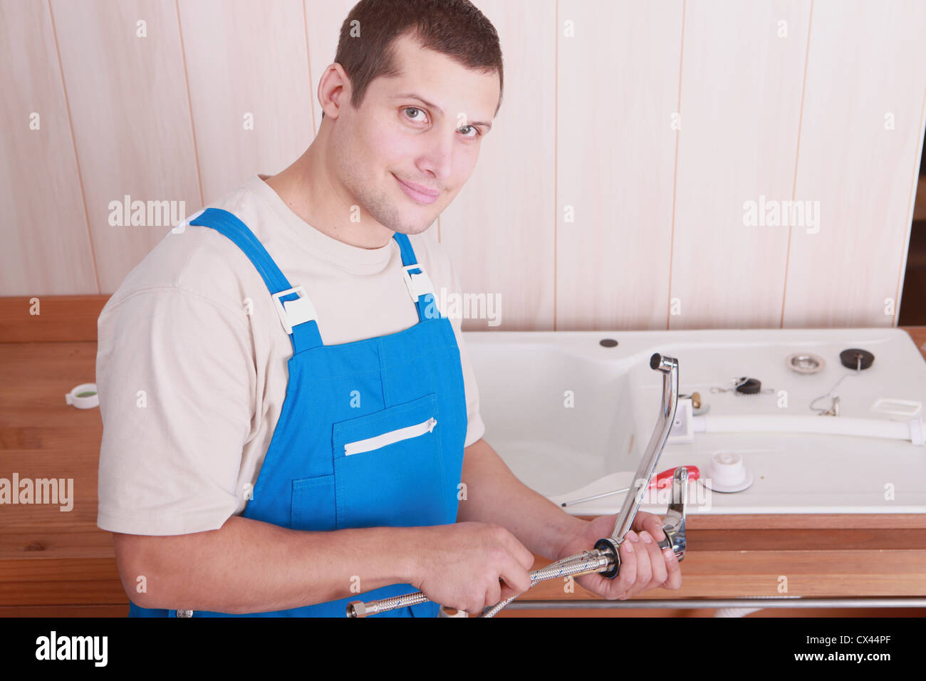 Plumber installing a kitchen sink Stock Photo - Alamy