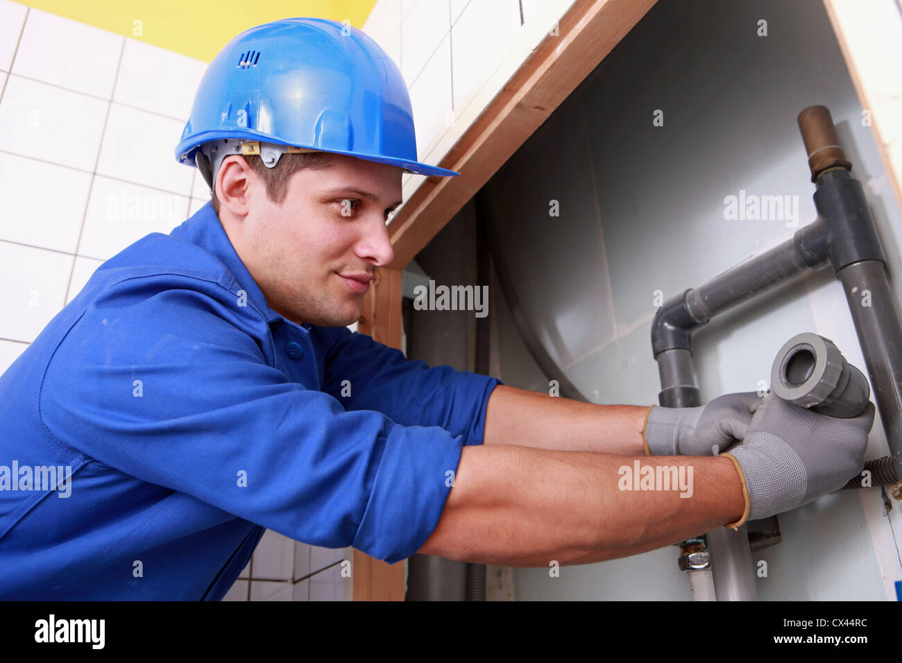 Plumbers install drainage Stock Photo - Alamy