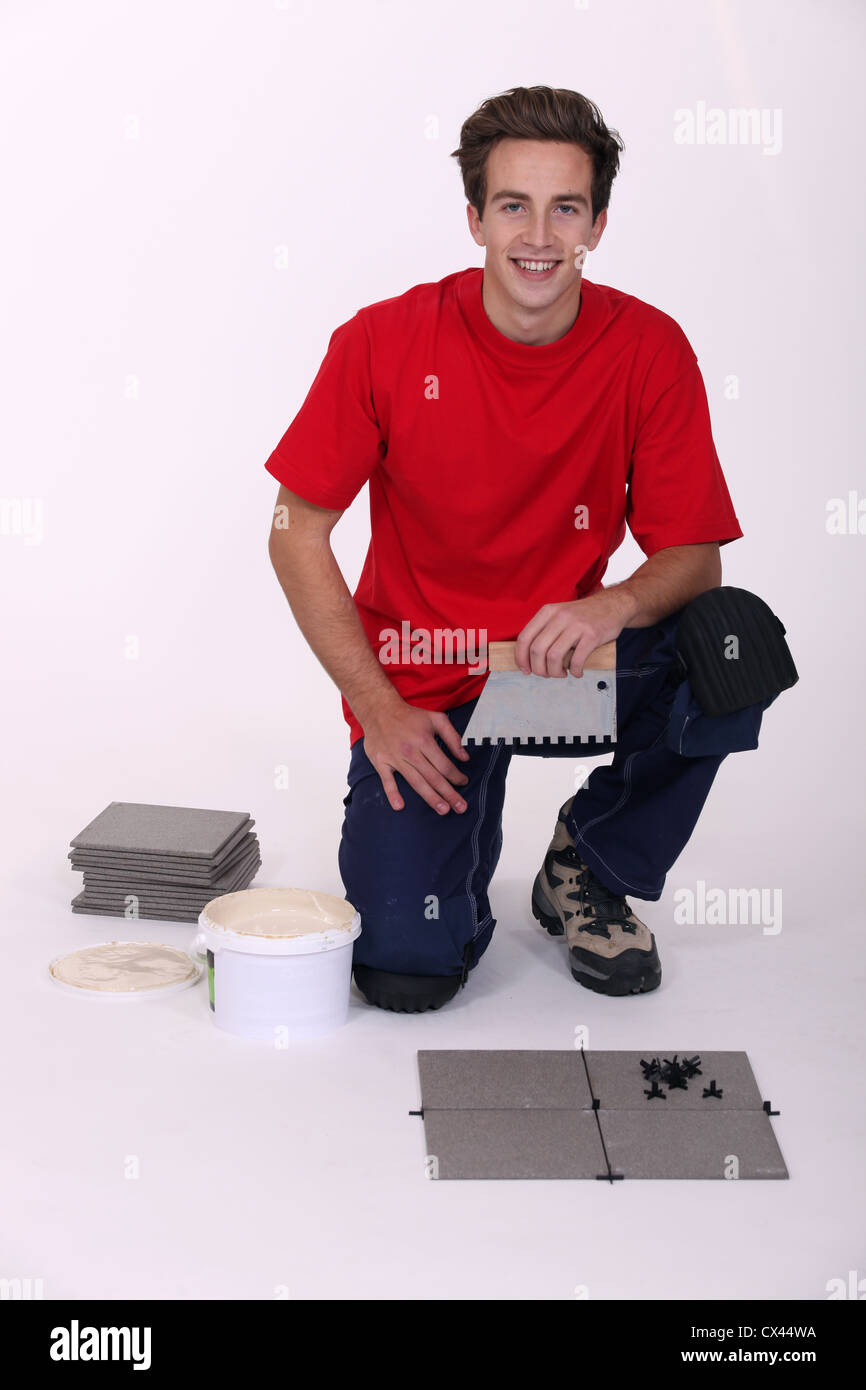 young man laying tiles Stock Photo - Alamy