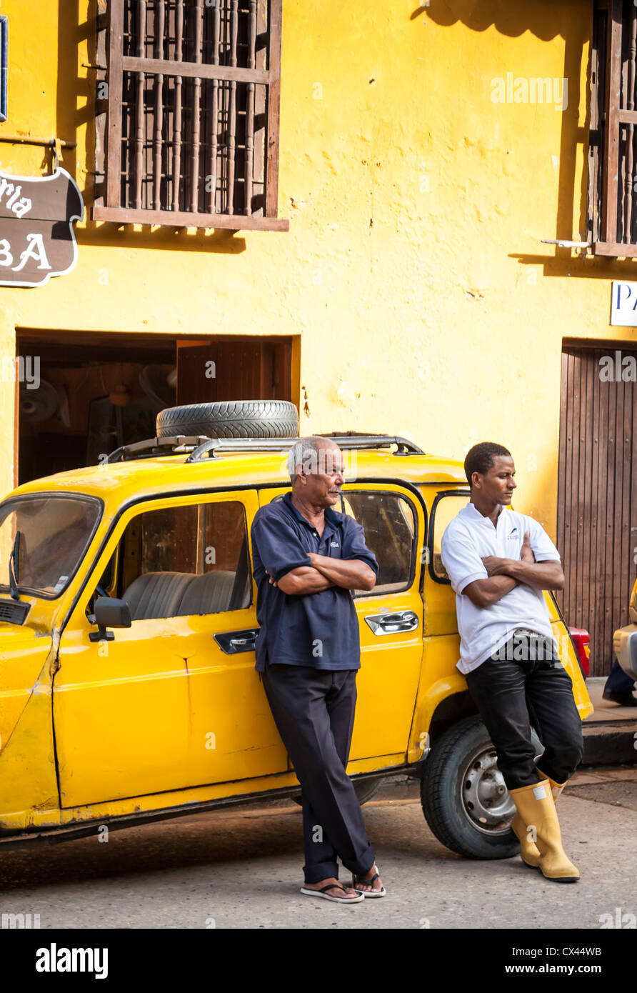 two men standing by a yellow car, Cartagena, Colombia Stock Photo - Alamy